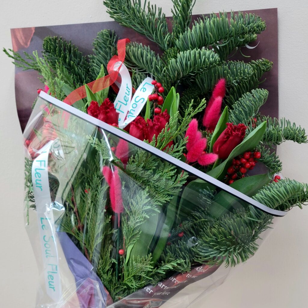 Bouquet with Christmas tree brunches and tulips or roses